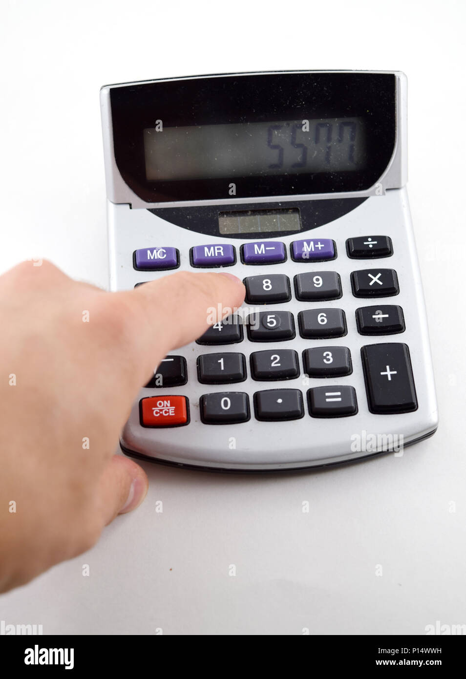 Hand pushing buttons on calculator Stock Photo - Alamy