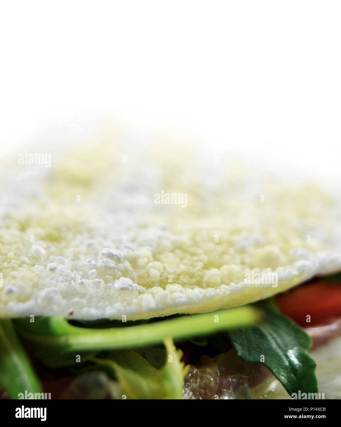 Brazilian tapioca on a plate filled with cheese, tomato, arugula, and ...