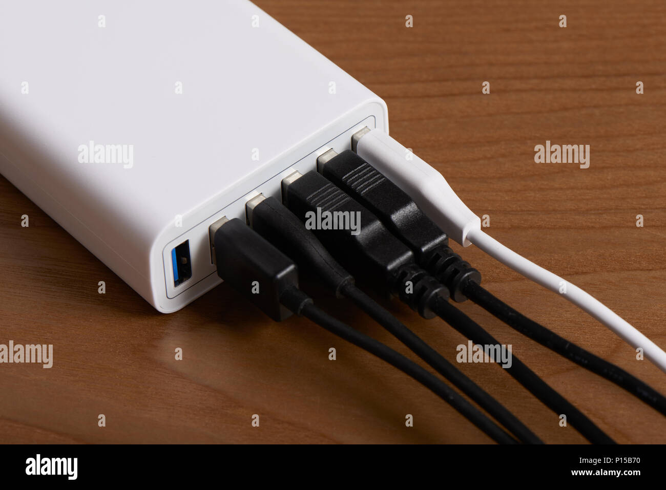 multiport charging station and charging cables on a wooden background ...