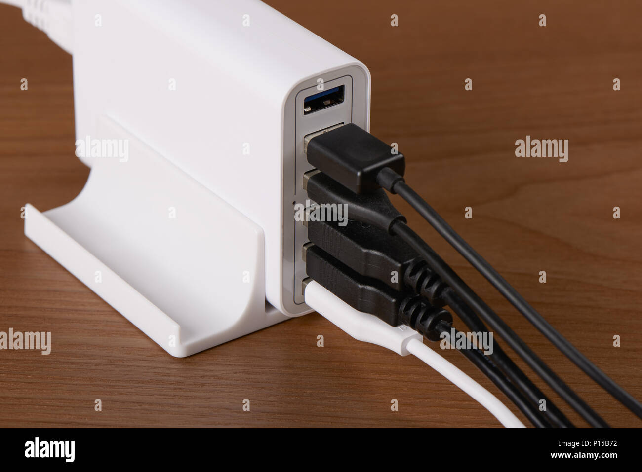 multiport charging station and charging cables on a wooden background ...