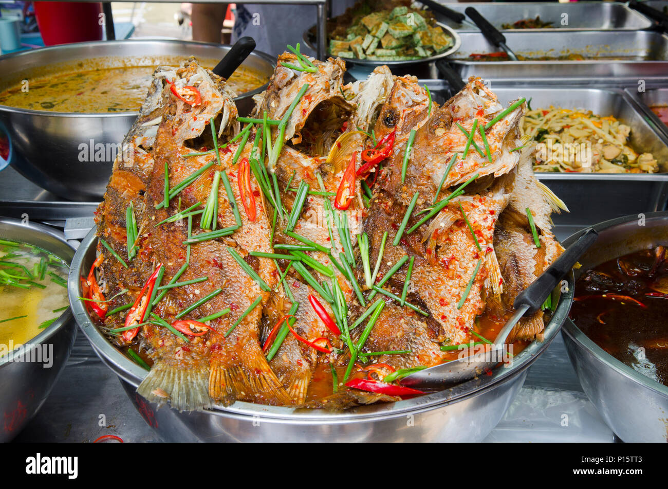 Freshly prepared Thai style whole fish red snapper dinner with tamarind ...