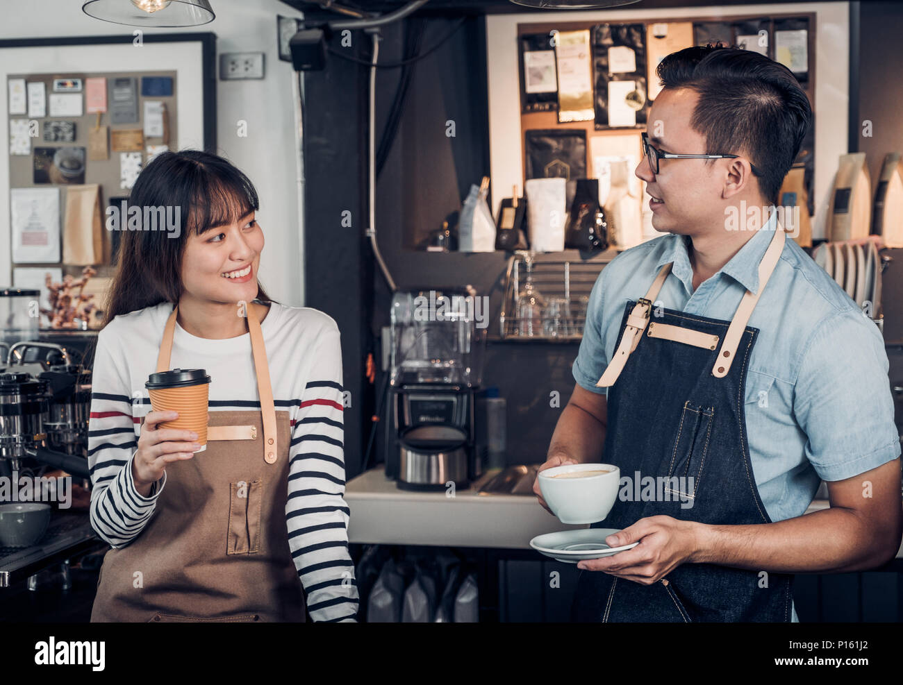 Two barista talking together about tasted of coffee cup with happy ...