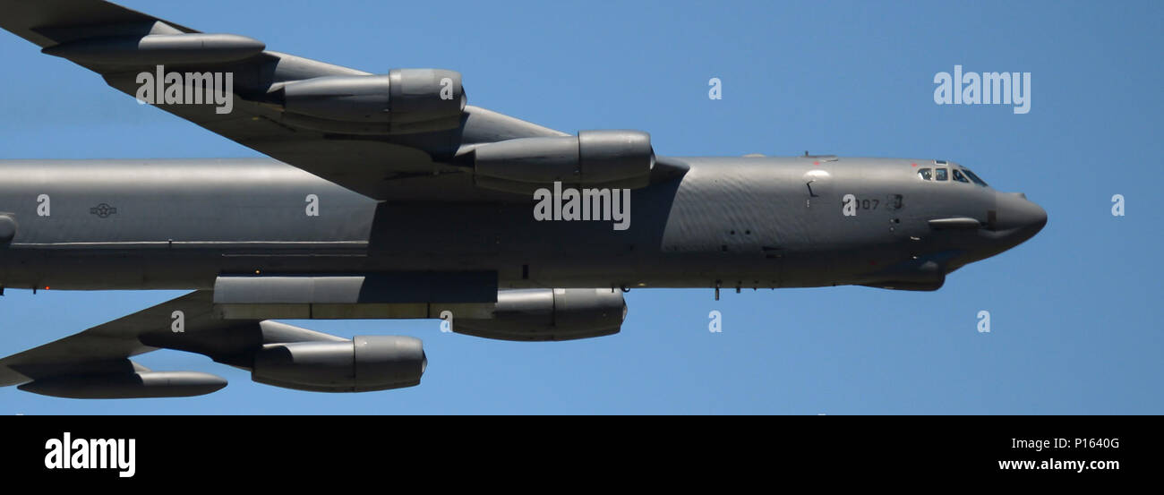 A B-52 Stratofortress flies at a low altitude with bomb bay doors open ...