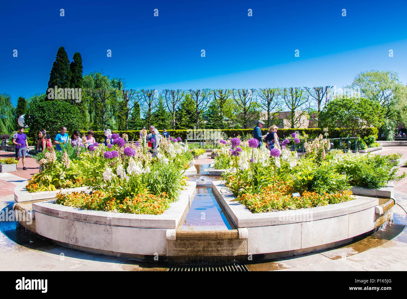 Fountain with flowers Stock Photo - Alamy