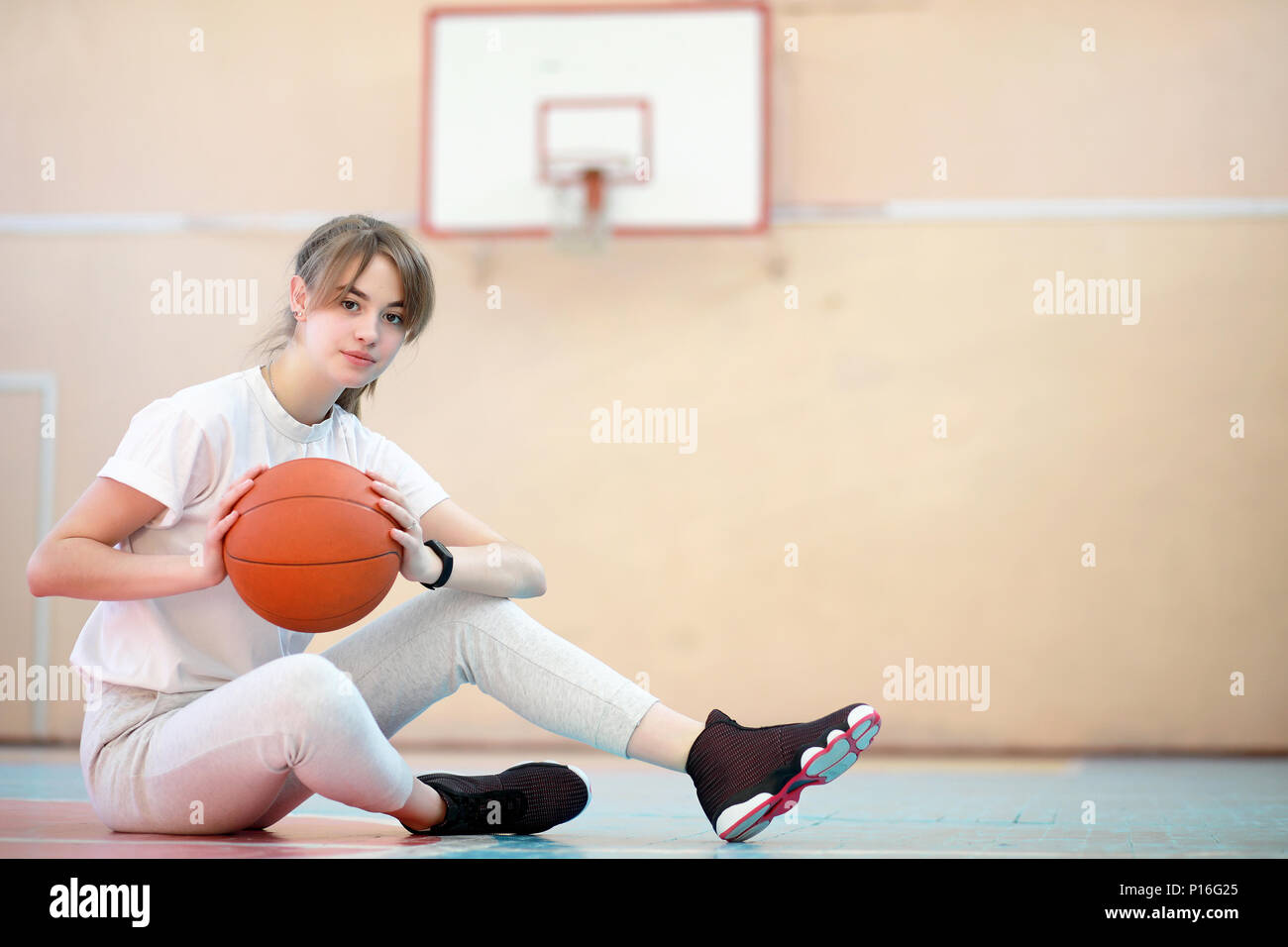 Girl young student in the gym playing a basketball Stock Photo - Alamy