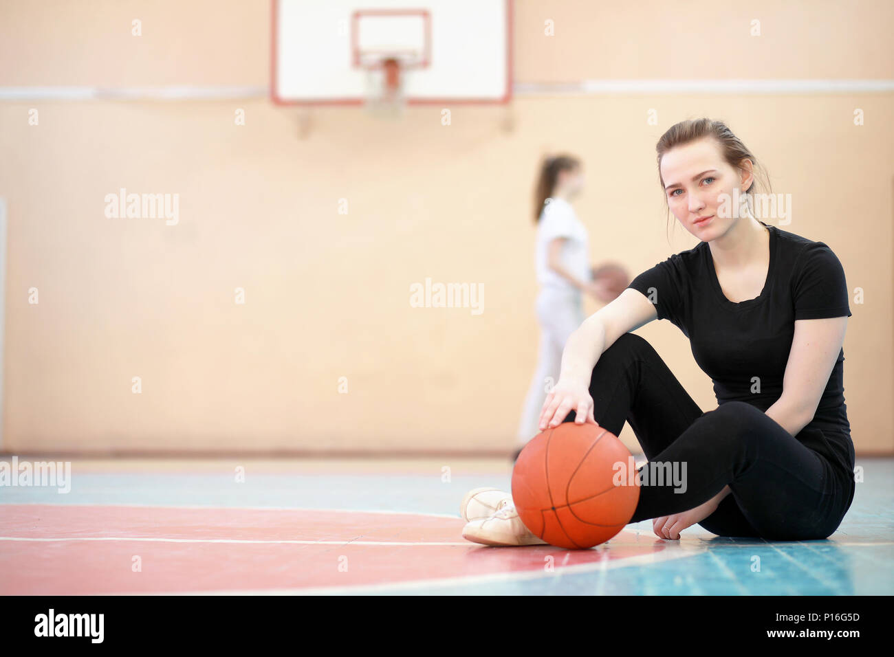 Girl young student in the gym playing a basketball Stock Photo - Alamy