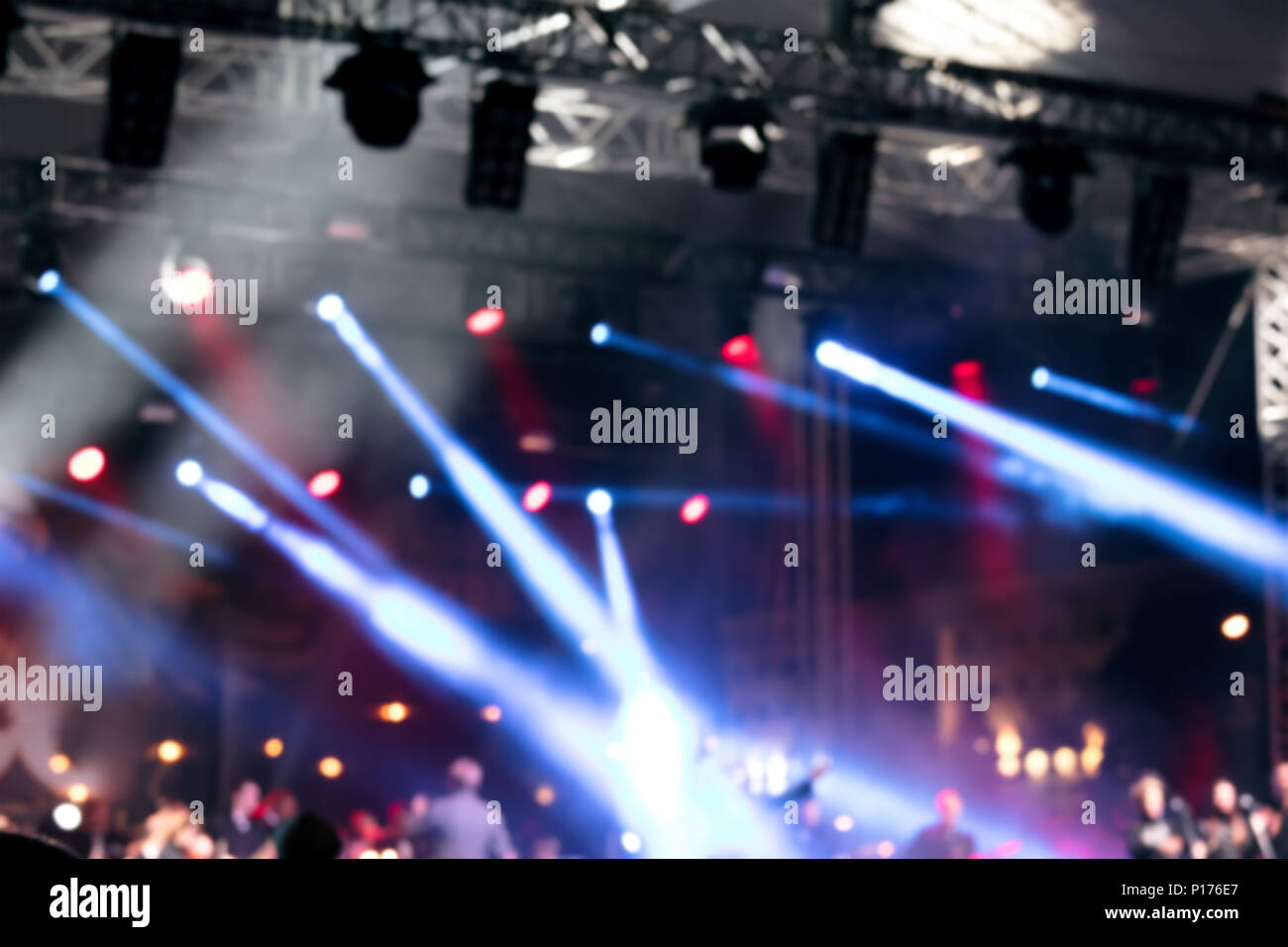 abstract blurred photo of spotlights and musicians during outdoor ...