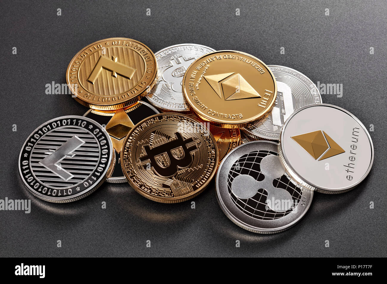 Different coins of crypto currency on a dark background Stock Photo - Alamy