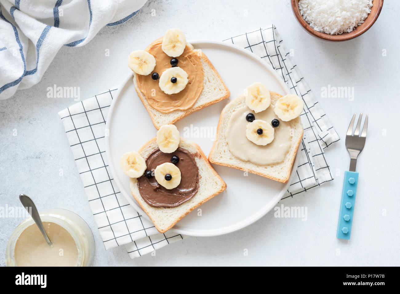 Breakfast toasts with nut butter and banana with cute funny animal face ...
