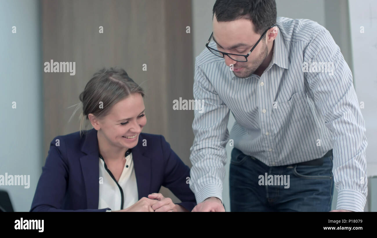 Two teachers are talking in the school hall to their next lesson ...