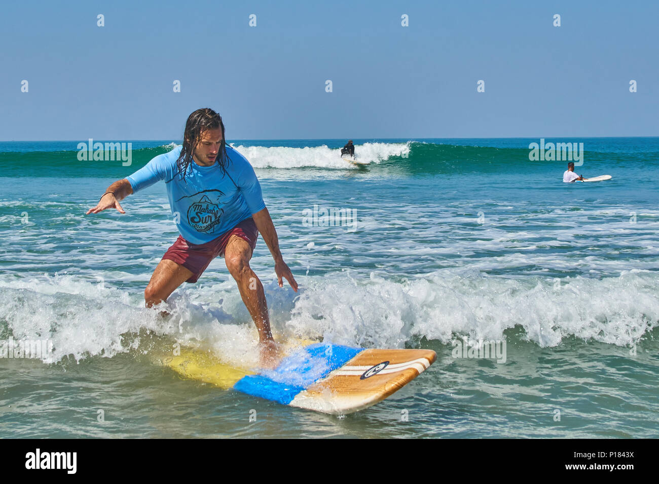 A student of Aloha surf India catching a wave on Agonda beach in Goa ...