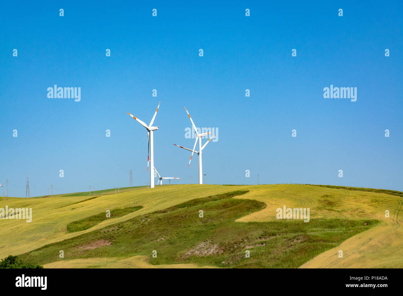 Modern wind farm with big wind turbines towers, source for renewable ...