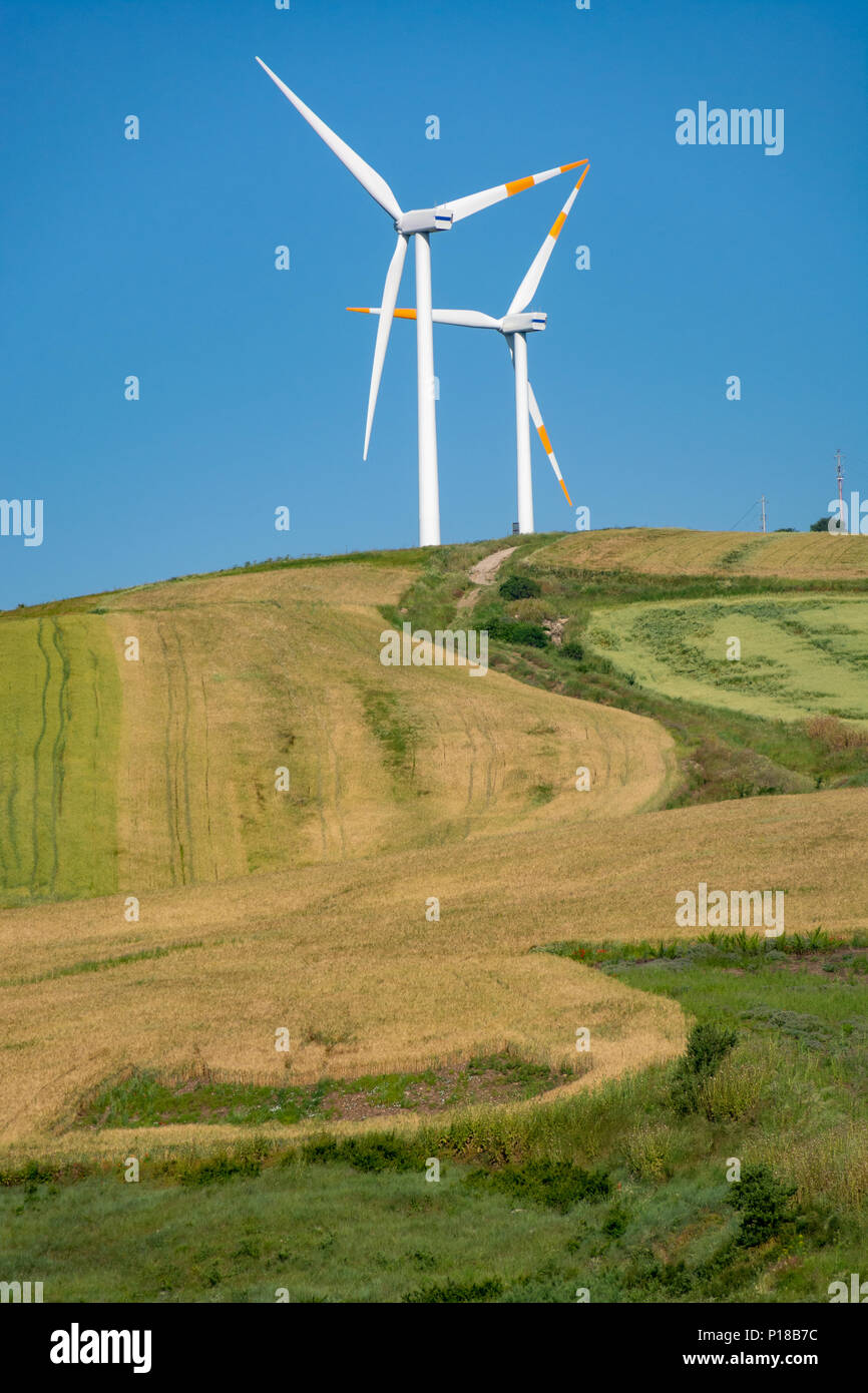 Modern wind farm with big wind turbines towers, source for renewable ...