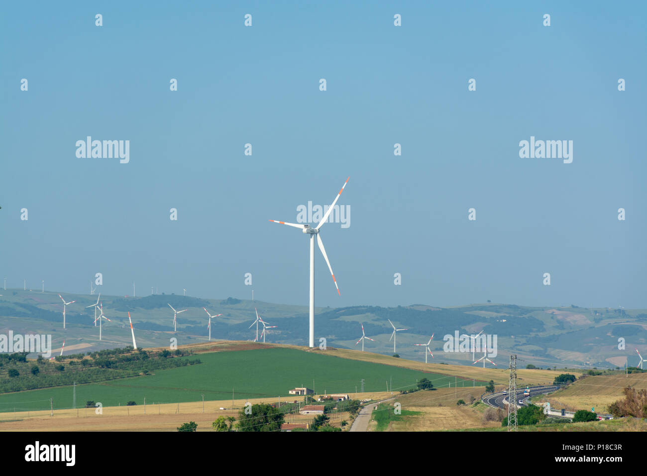 Modern wind farm with big wind turbines towers, source for renewable ...