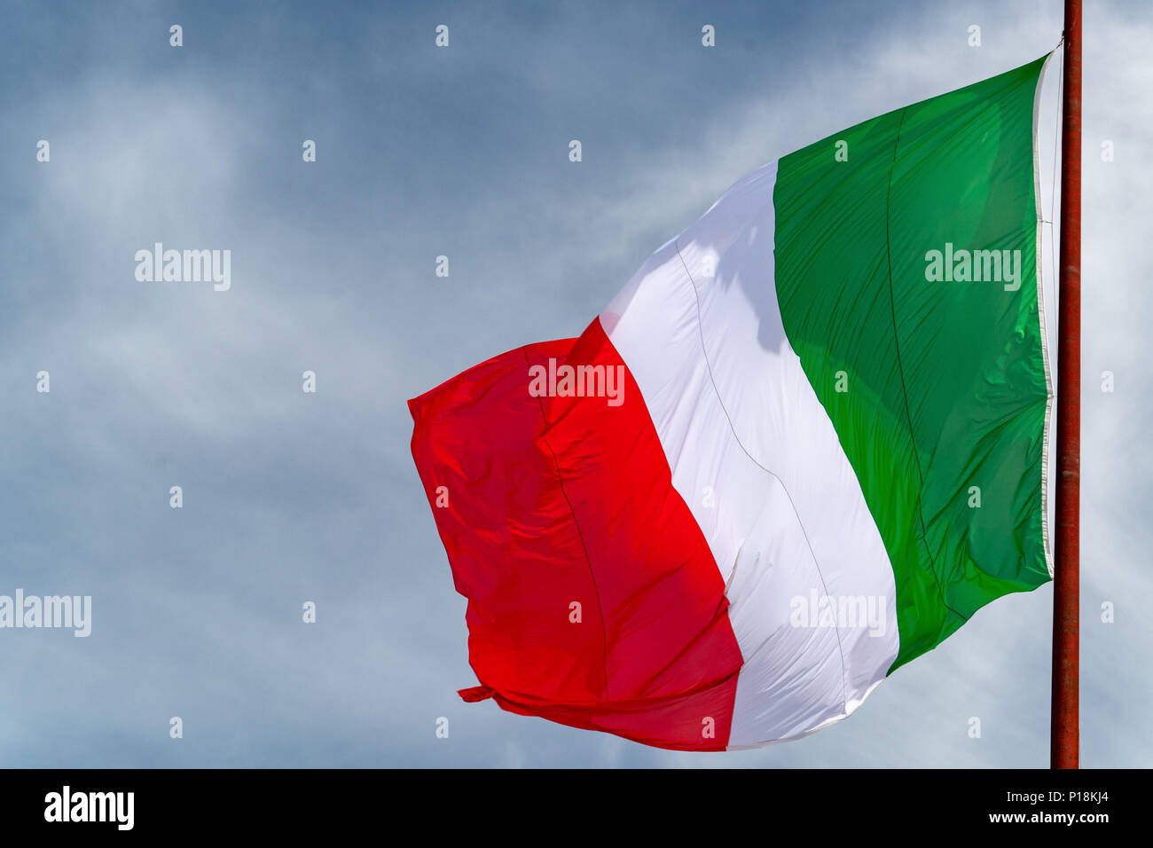 Italian three colors flag of Italy on the blue sky background Stock ...