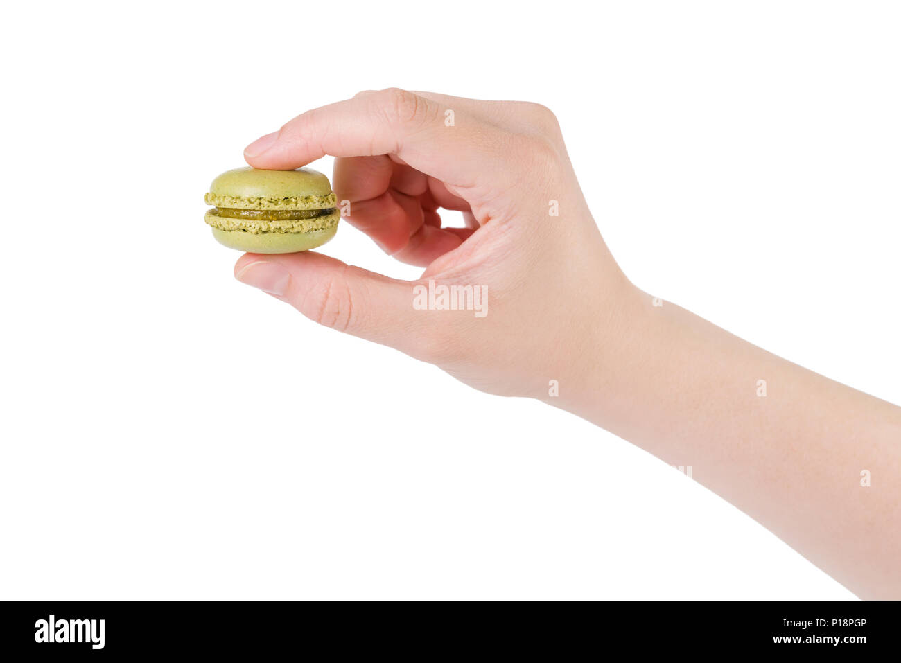 young female hand holding green macaron isolated on white Stock Photo ...