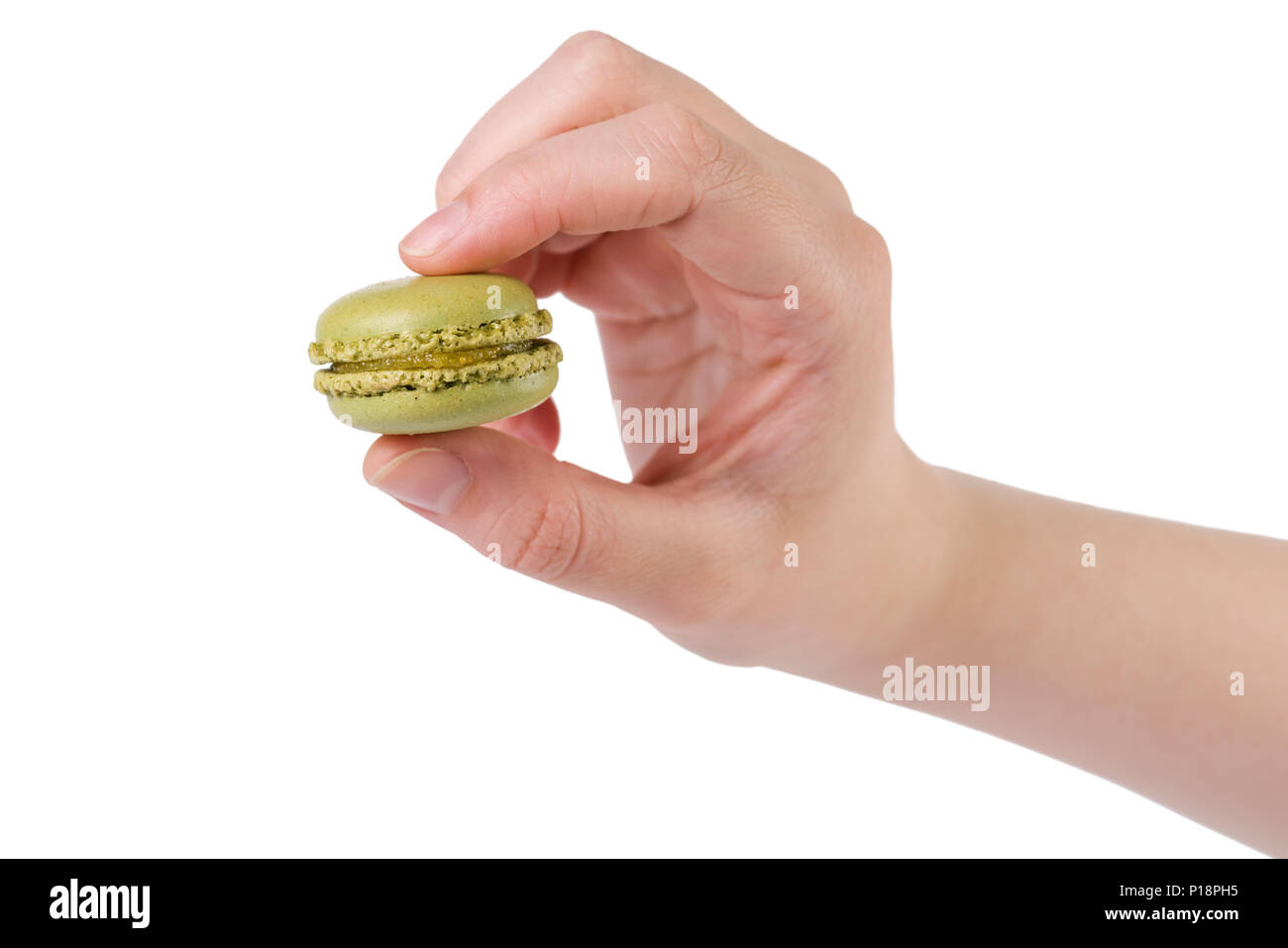young female hand holding green macaron isolated on white Stock Photo ...