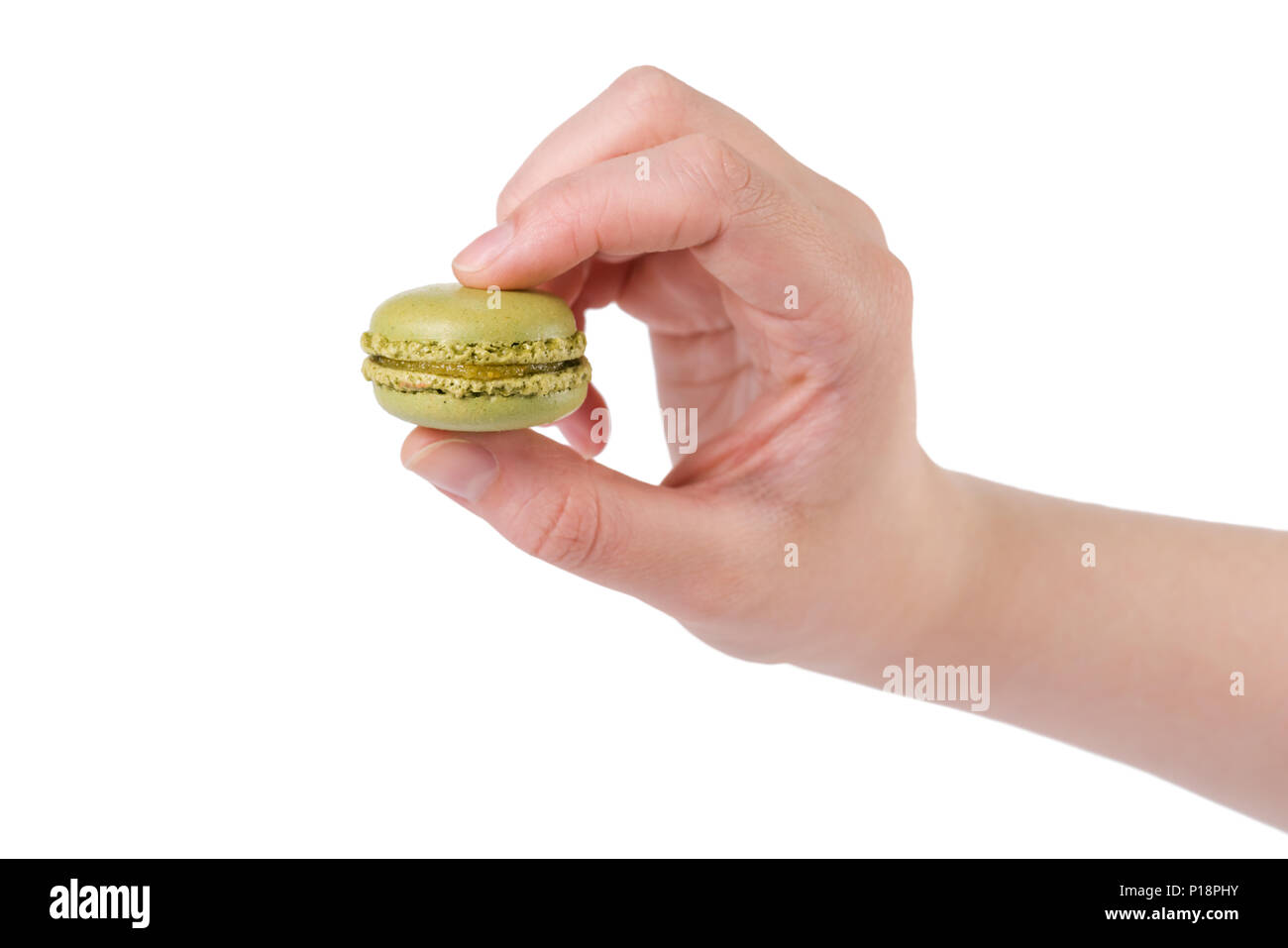 young female hand holding green macaron isolated on white Stock Photo ...