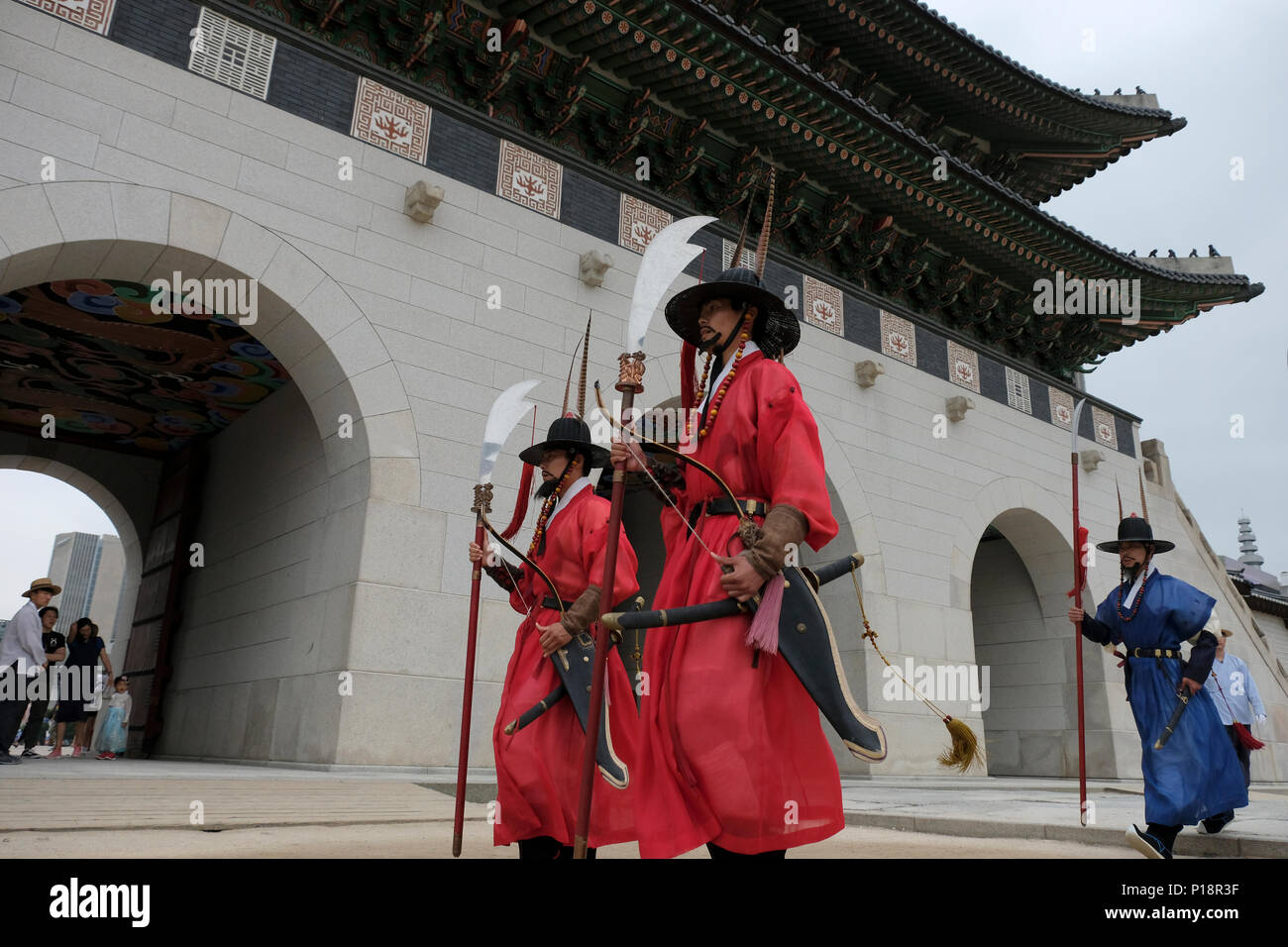 Men in traditional attire perform the Royal Guard Changing Ceremony ...