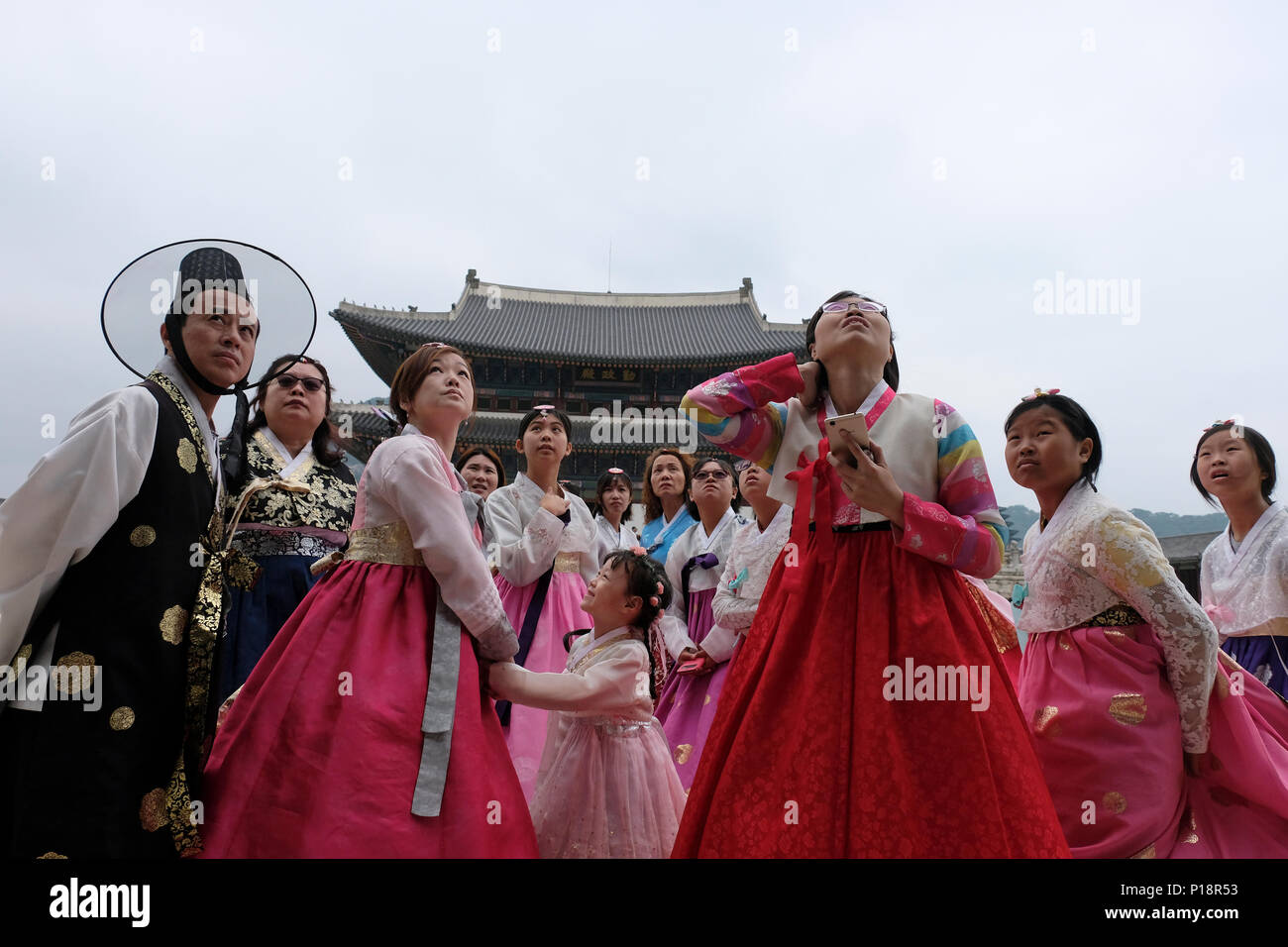 Visitors in traditional costumes at Gyeongbokgung or Gyeongbok Palace ...