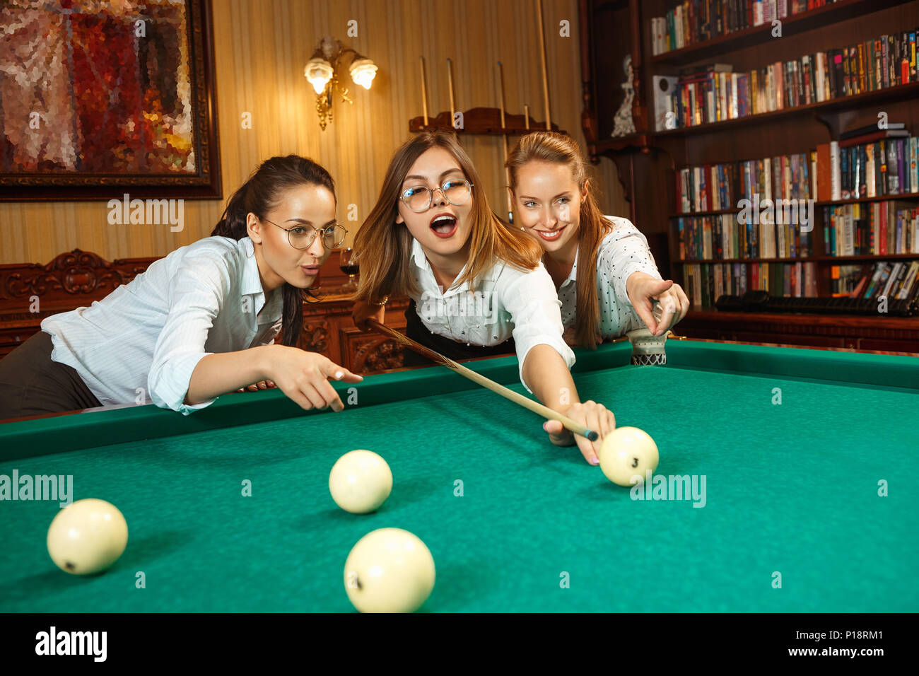 Young women playing billiards at office after work Stock Photo - Alamy