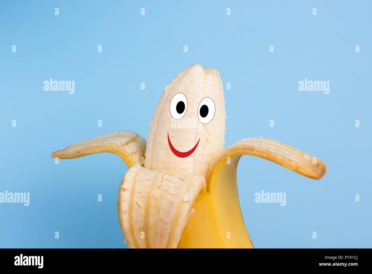 banana character smile on the blue background Stock Photo - Alamy