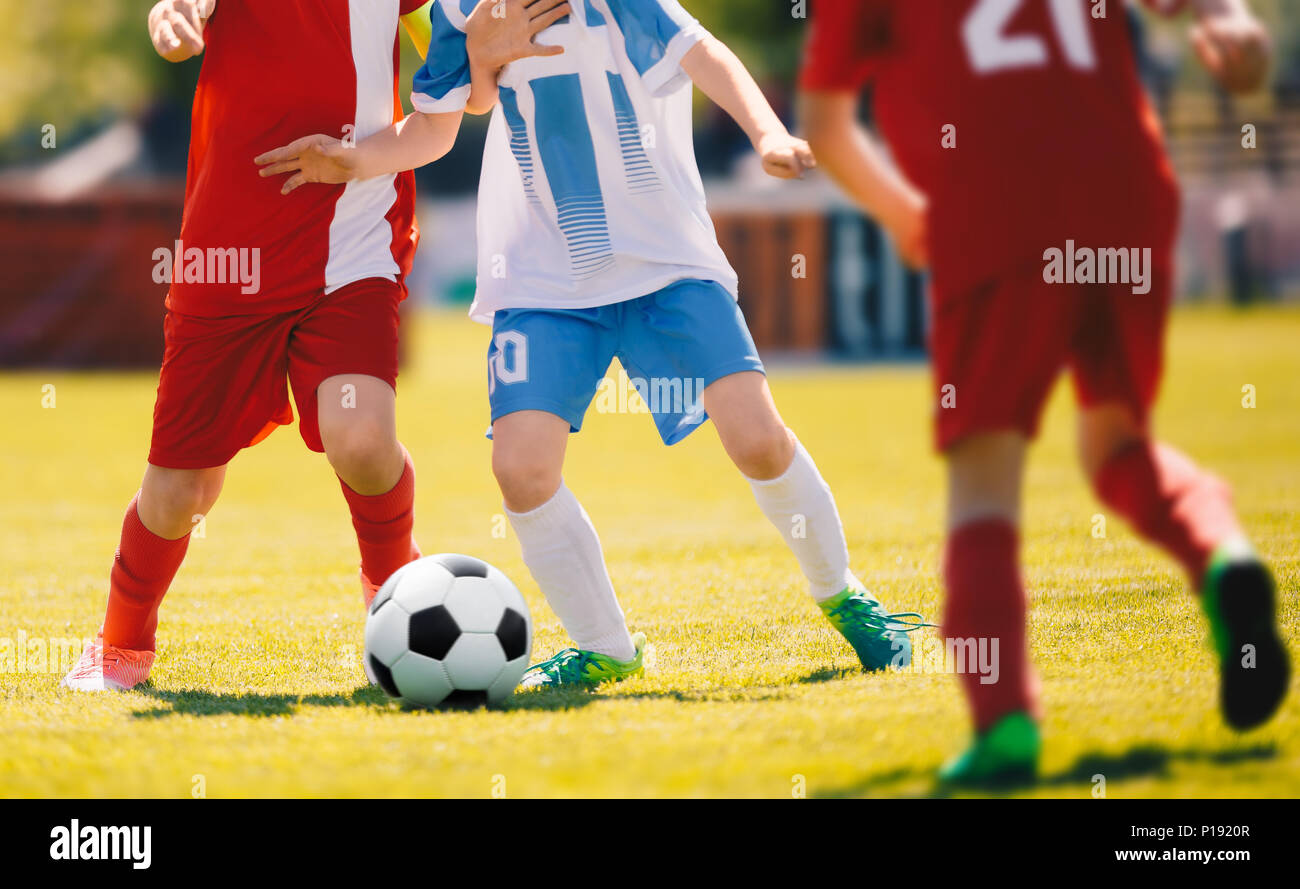 Junior Football Match Competition. Two Young Footballers Running and ...