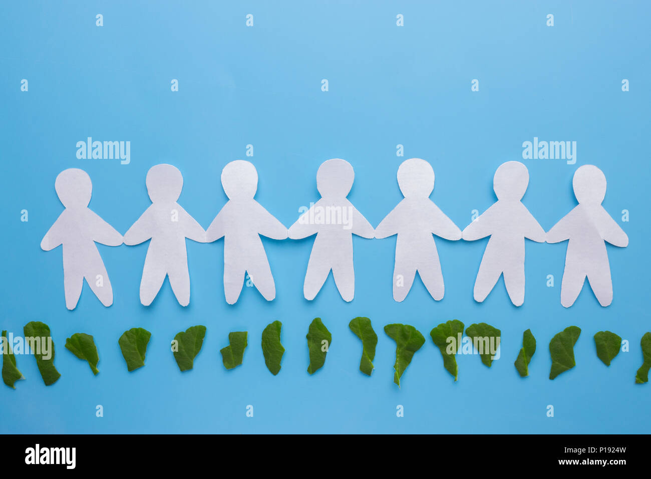 Paper people on the blue background. together possible Stock Photo - Alamy