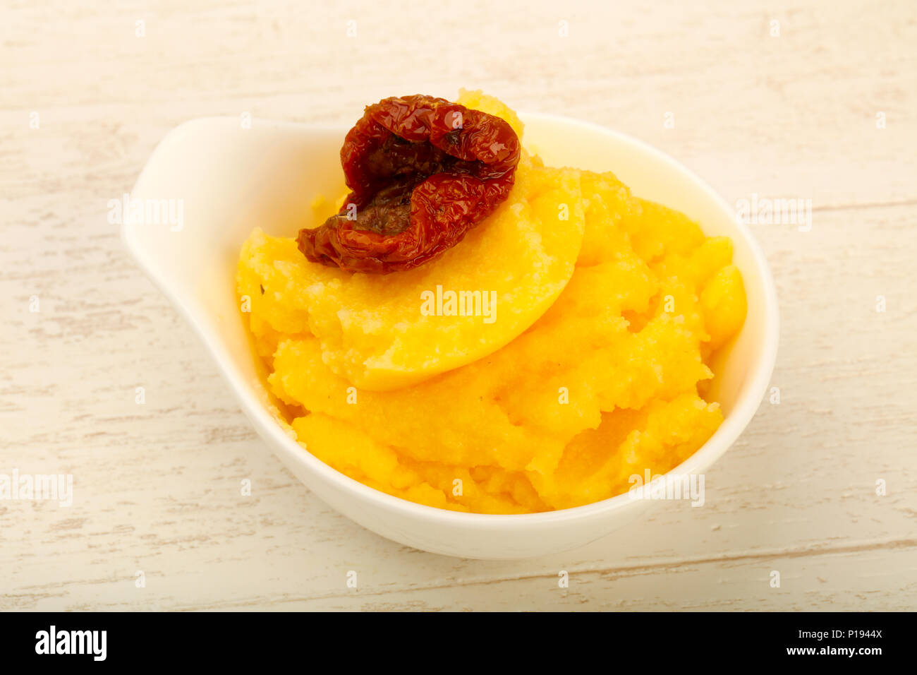 Polenta with dry tomato Stock Photo - Alamy