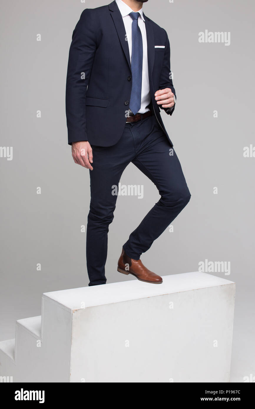 Businessman body step up on stairs studio shoot Stock Photo - Alamy