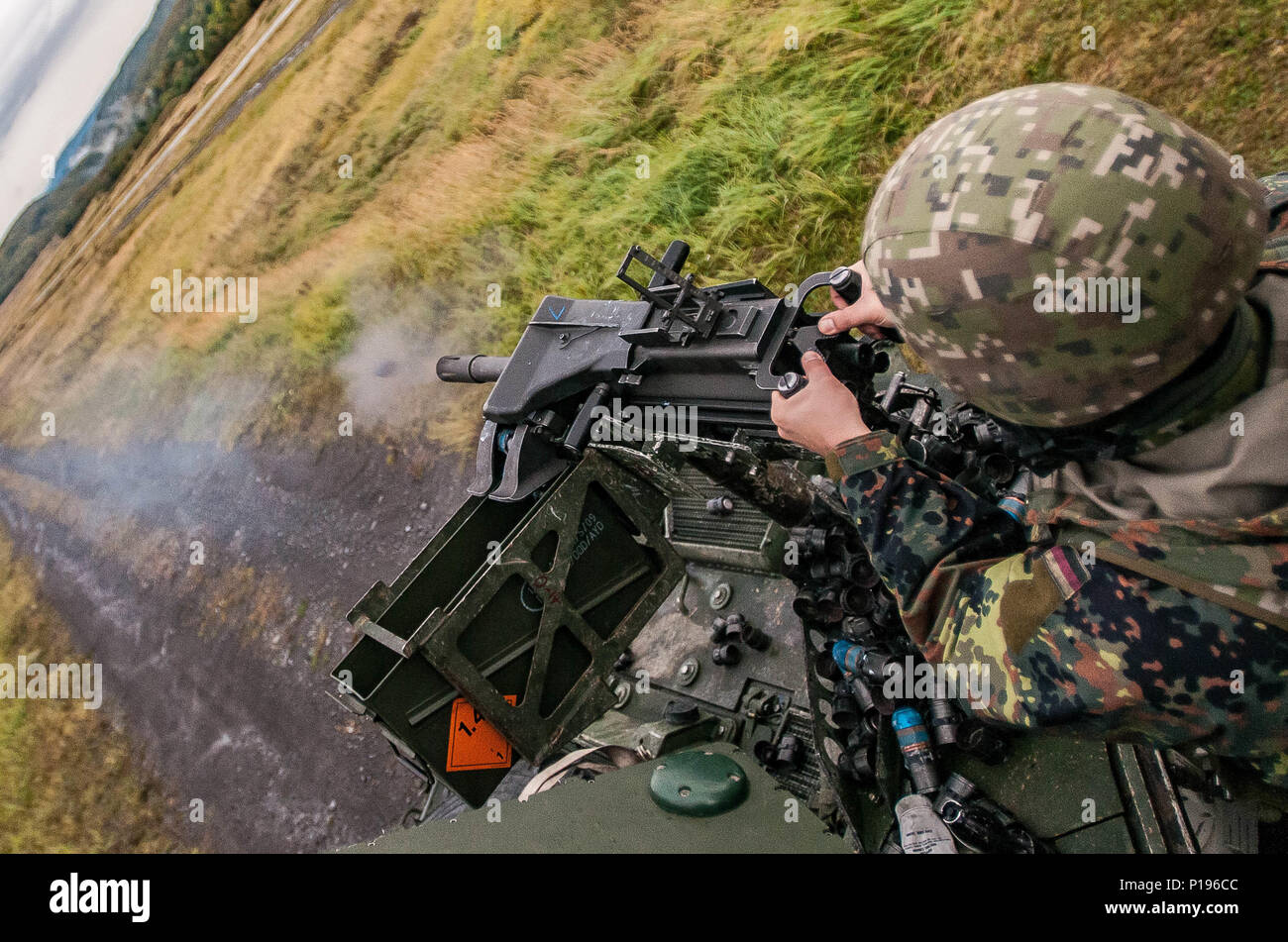 A Slovakian soldier shoots an MK-19 grenade launcher mounted on an ...