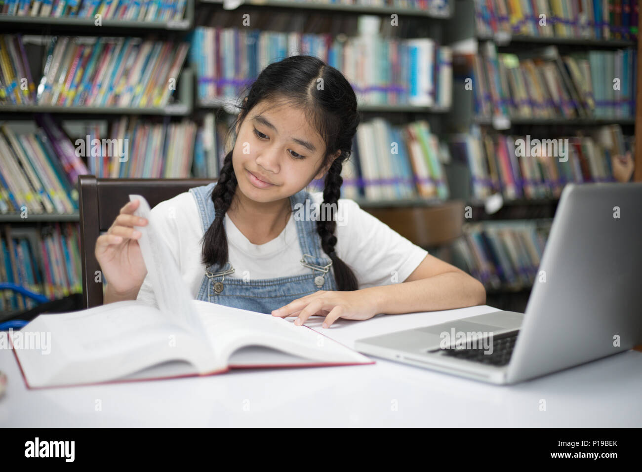 Asian students reading books in the library Stock Photo - Alamy