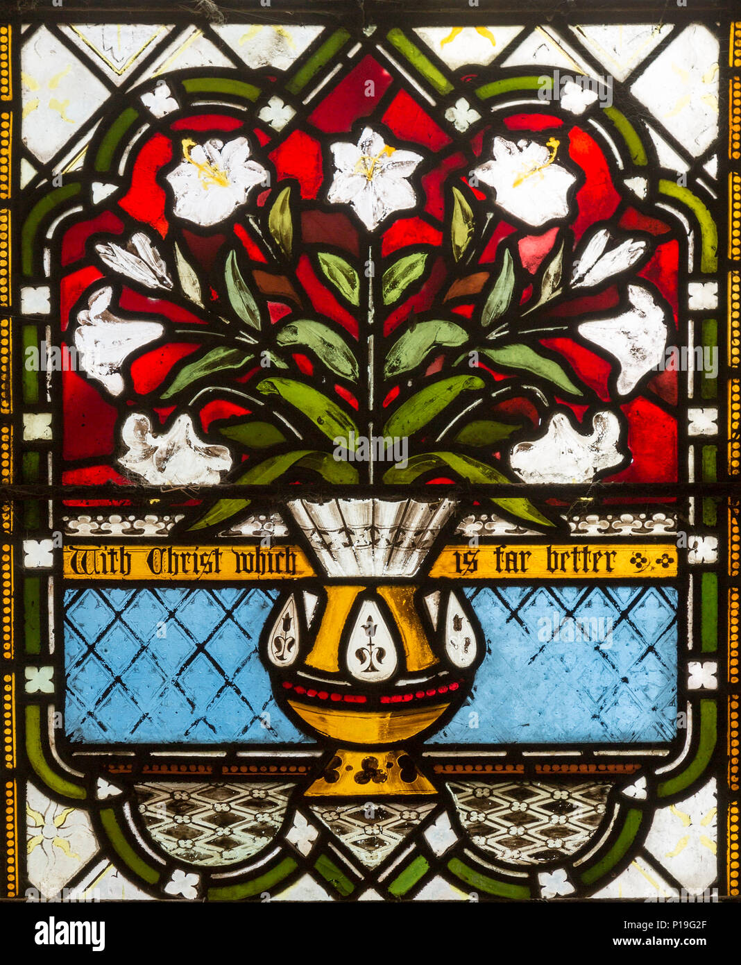 Memorial stained glass window of vase and lily flowers, in village ...