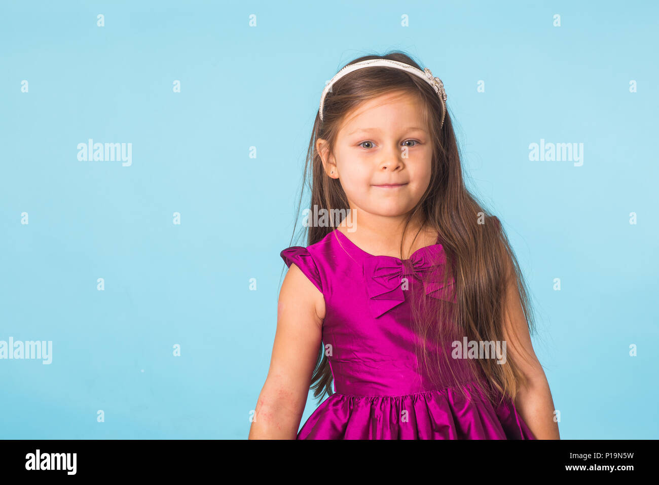 cute cheerful little girl portrait, isolated on blue background Stock ...