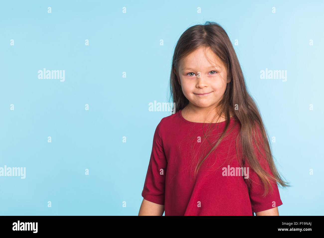 cute cheerful little girl portrait, isolated on blue background Stock ...
