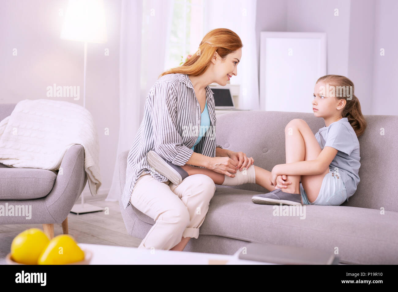 Pleasant nice woman caring about the child Stock Photo - Alamy