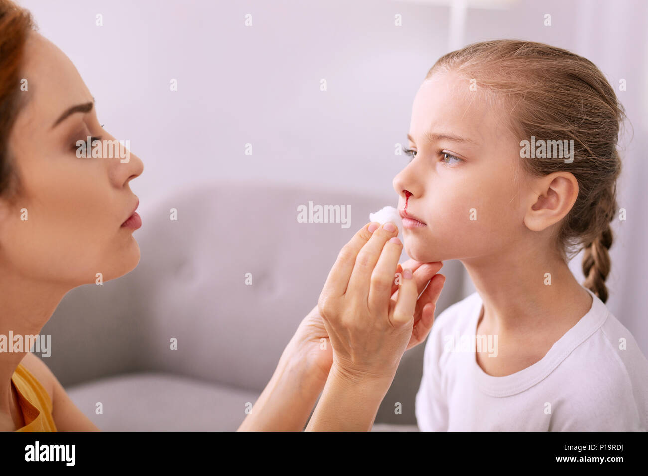 Pretty sad girl standing in front of her mother Stock Photo - Alamy