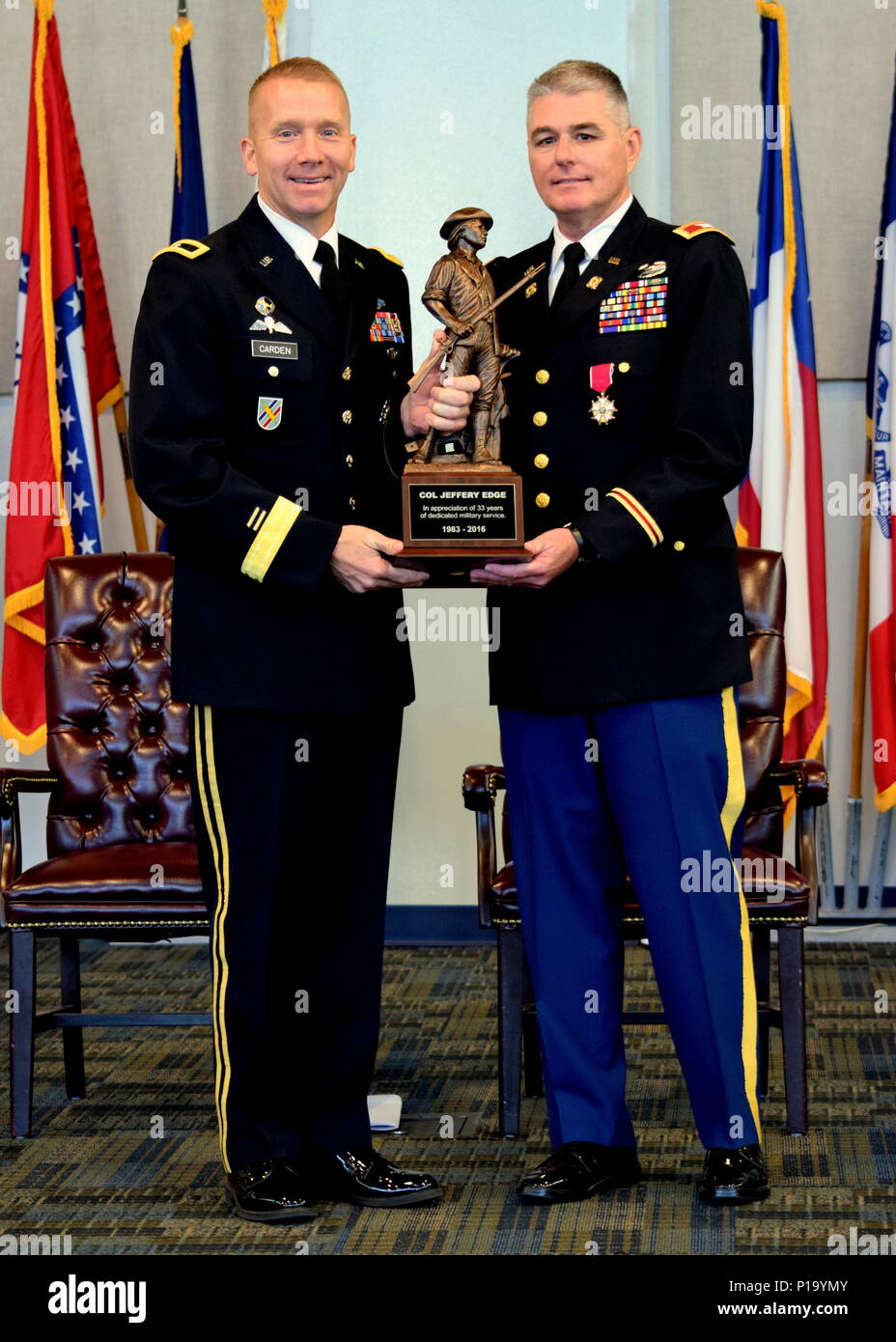 Colonel Jeff Edge receives the Minuteman statue from Brig. Gen. Tom ...