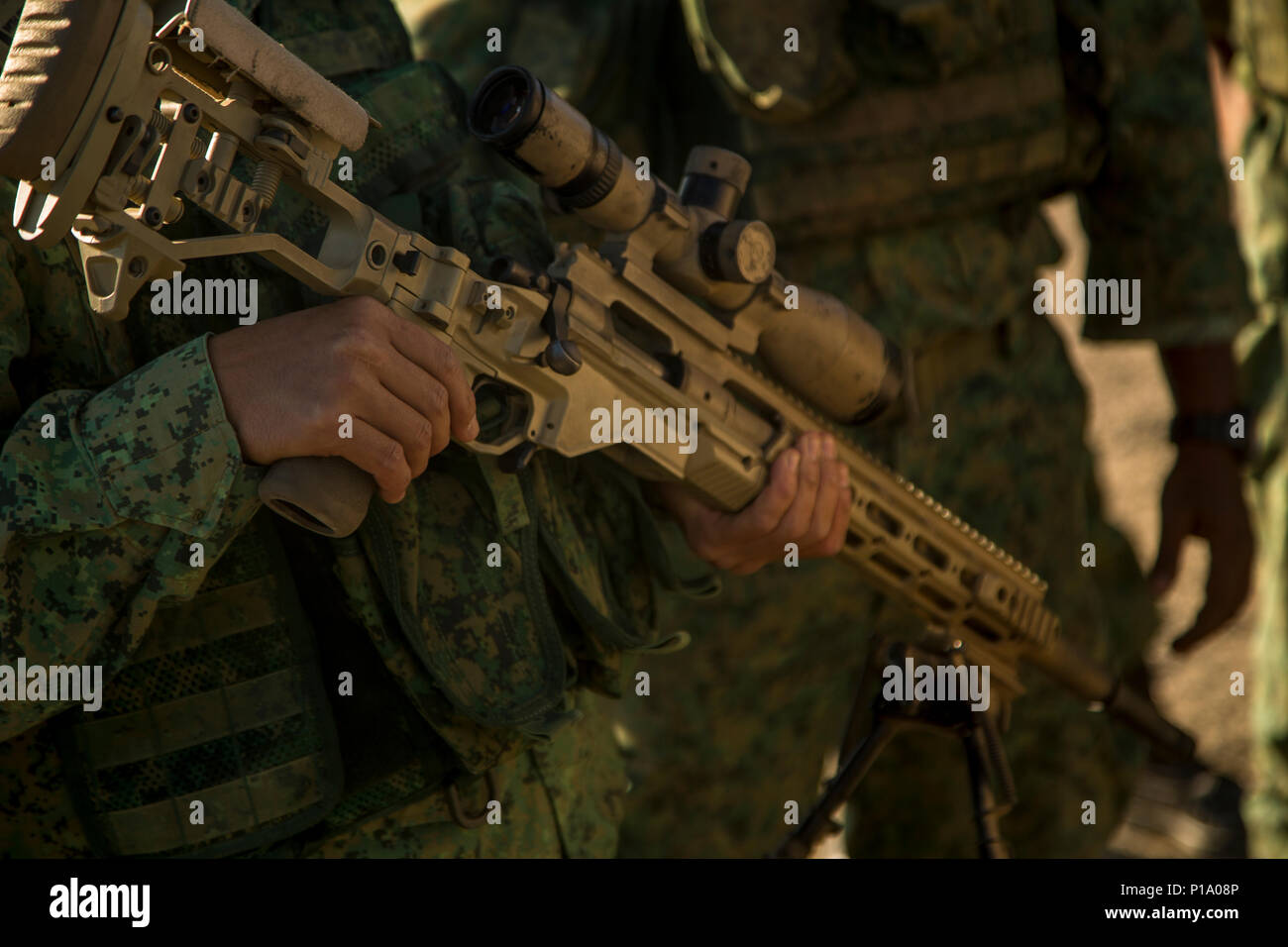 Members of the Singapore Armed Forces handle a U.S. Marine Corps M40A6 ...