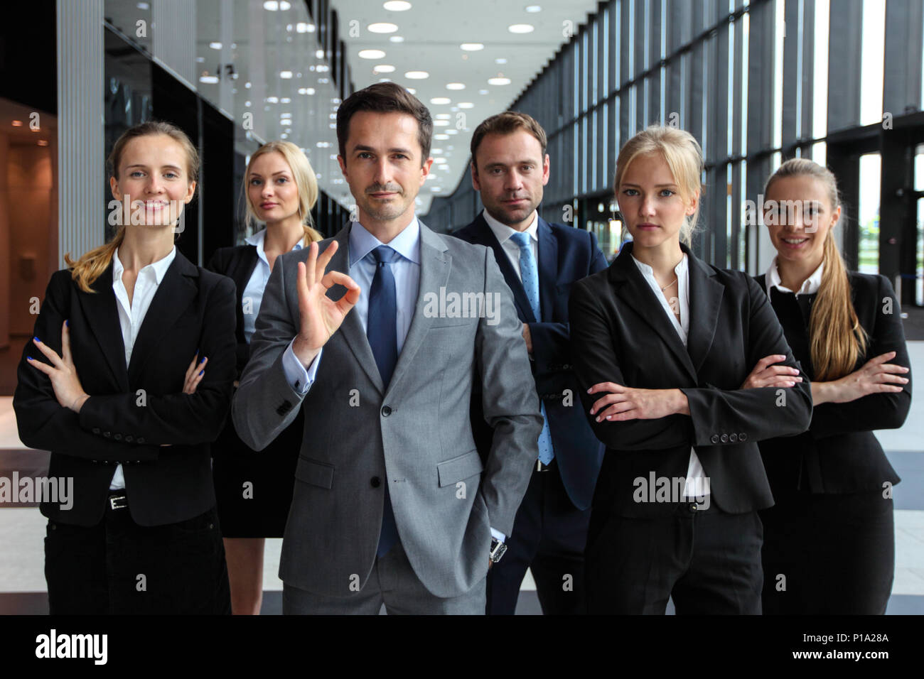Portrait of successful business people team standing together in modern ...