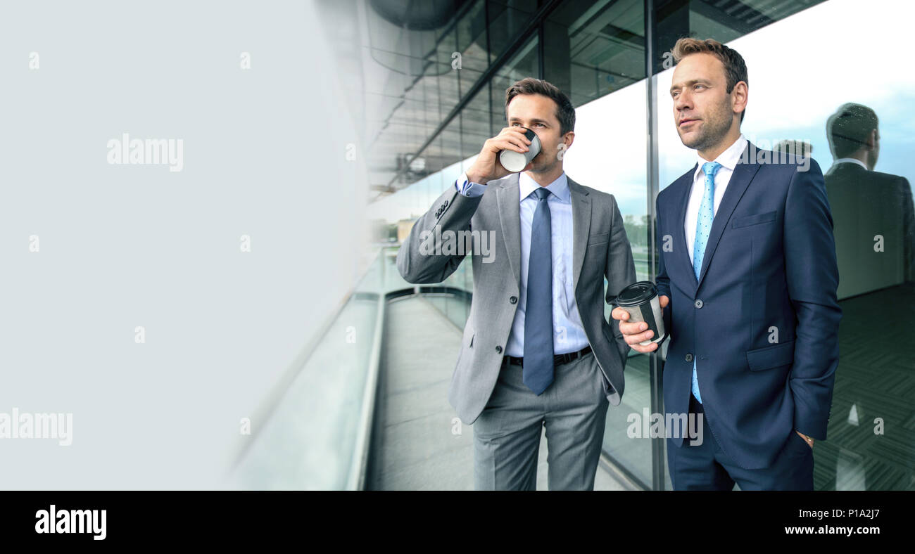 Business people having coffee break at the balcony of office building ...