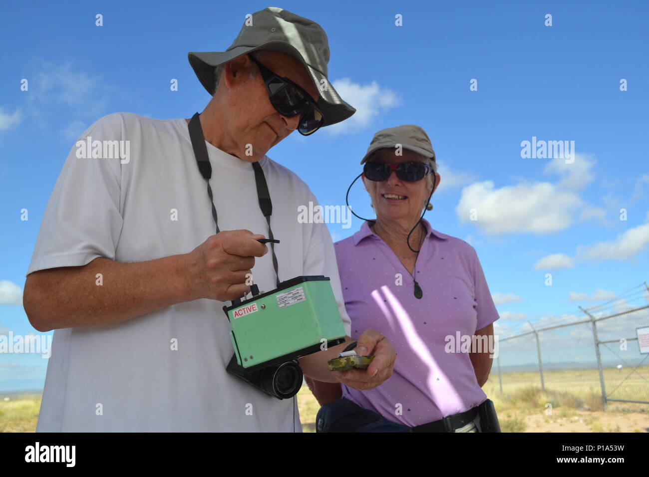 Barry Lennox, left, tests a piece of uranium with a radiation detection ...