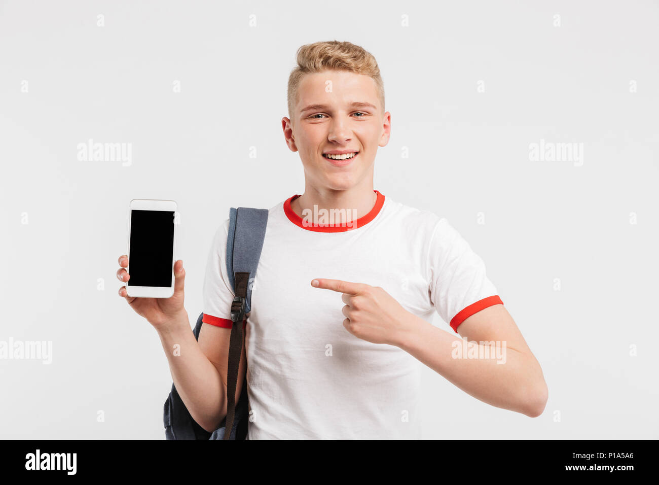 Image of happy male student having clean healthy skin wearing backpack ...