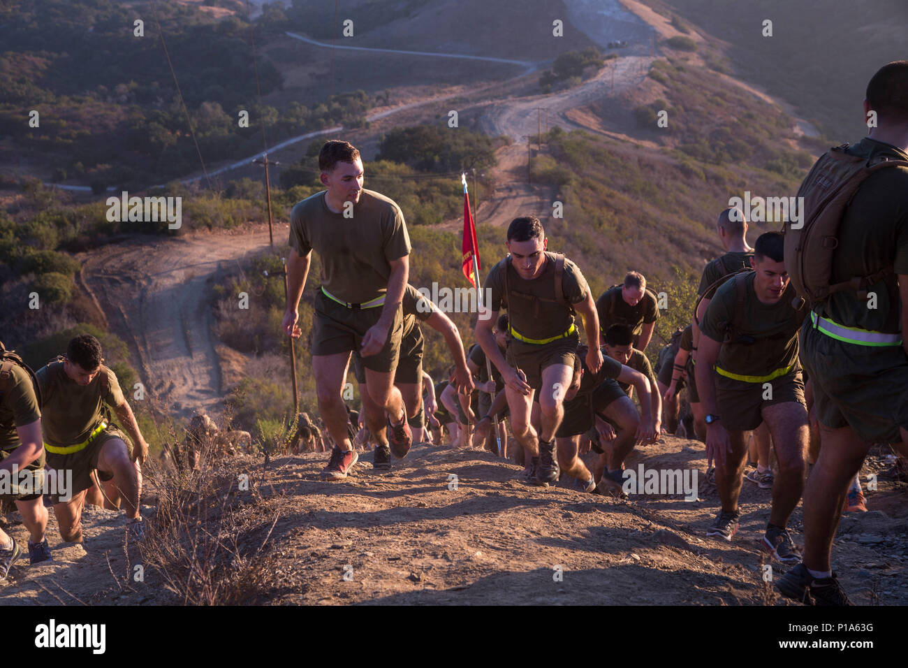 U.S. Marines with the 13th Marine Expeditionary Unit climb a hill to ...