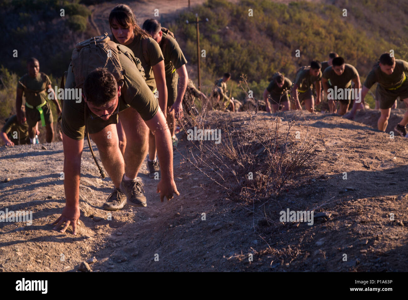 U.S. Marines with the 13th Marine Expeditionary Unit climb a hill to ...