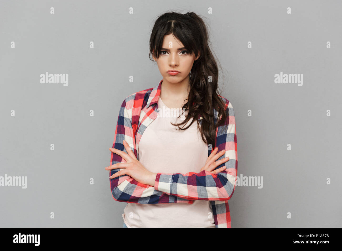 Image of displeased sad young lady standing isolated over grey ...