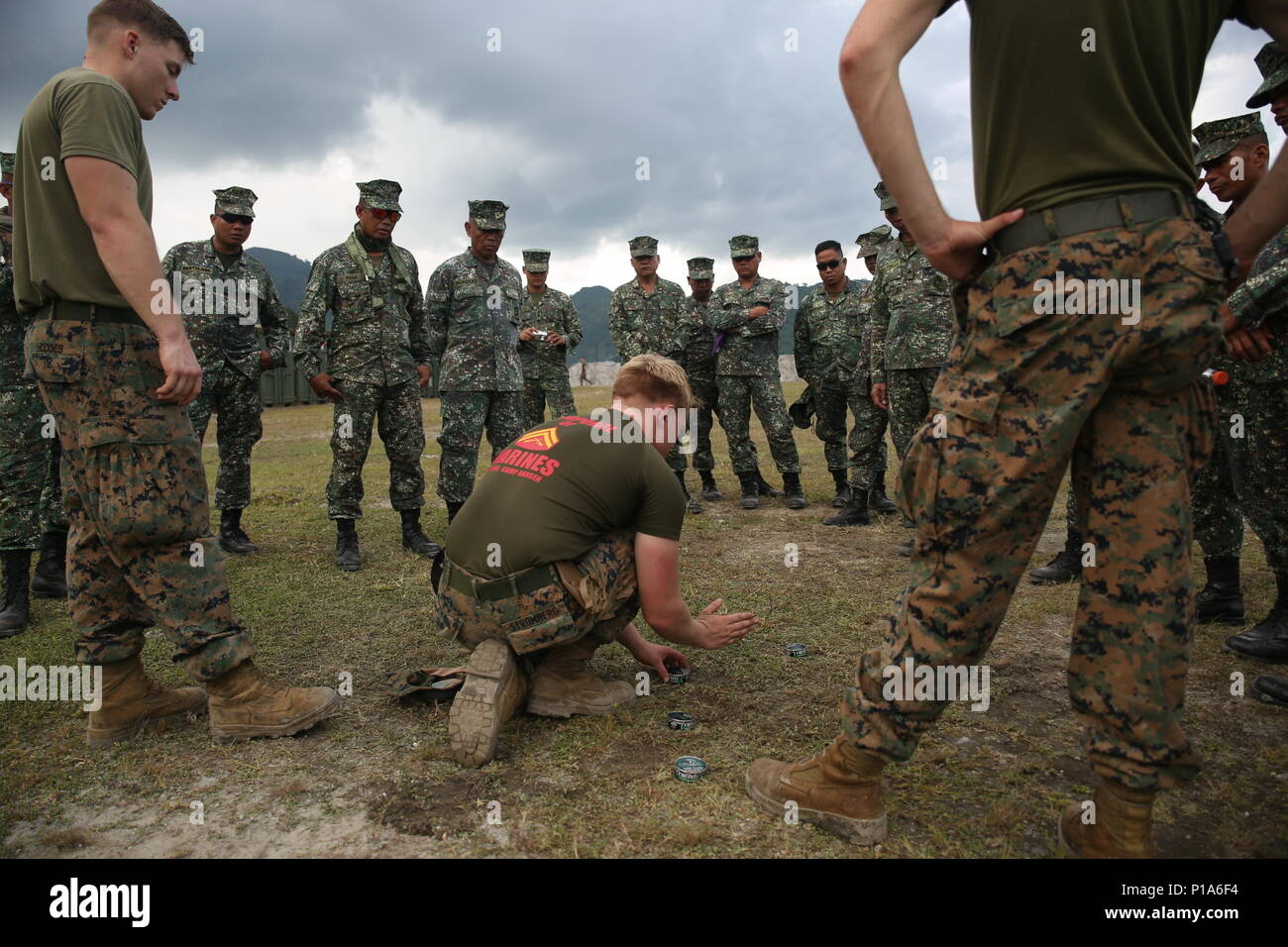 Cpl. Anders Stromberg (kneeling), a U.S. Marine Corps military police ...