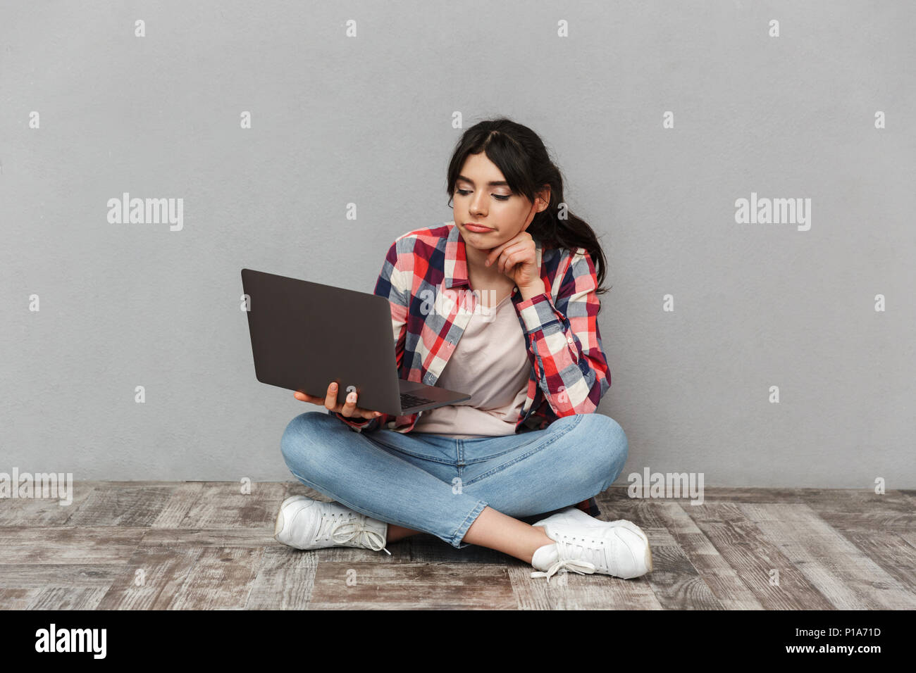 Image of sad young lady student isolated over grey background wall ...