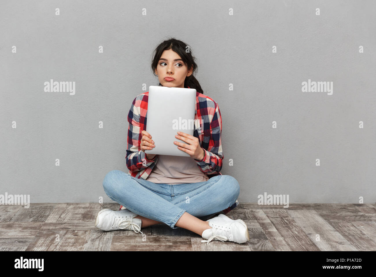 Image of sad young lady student isolated over grey background wall ...