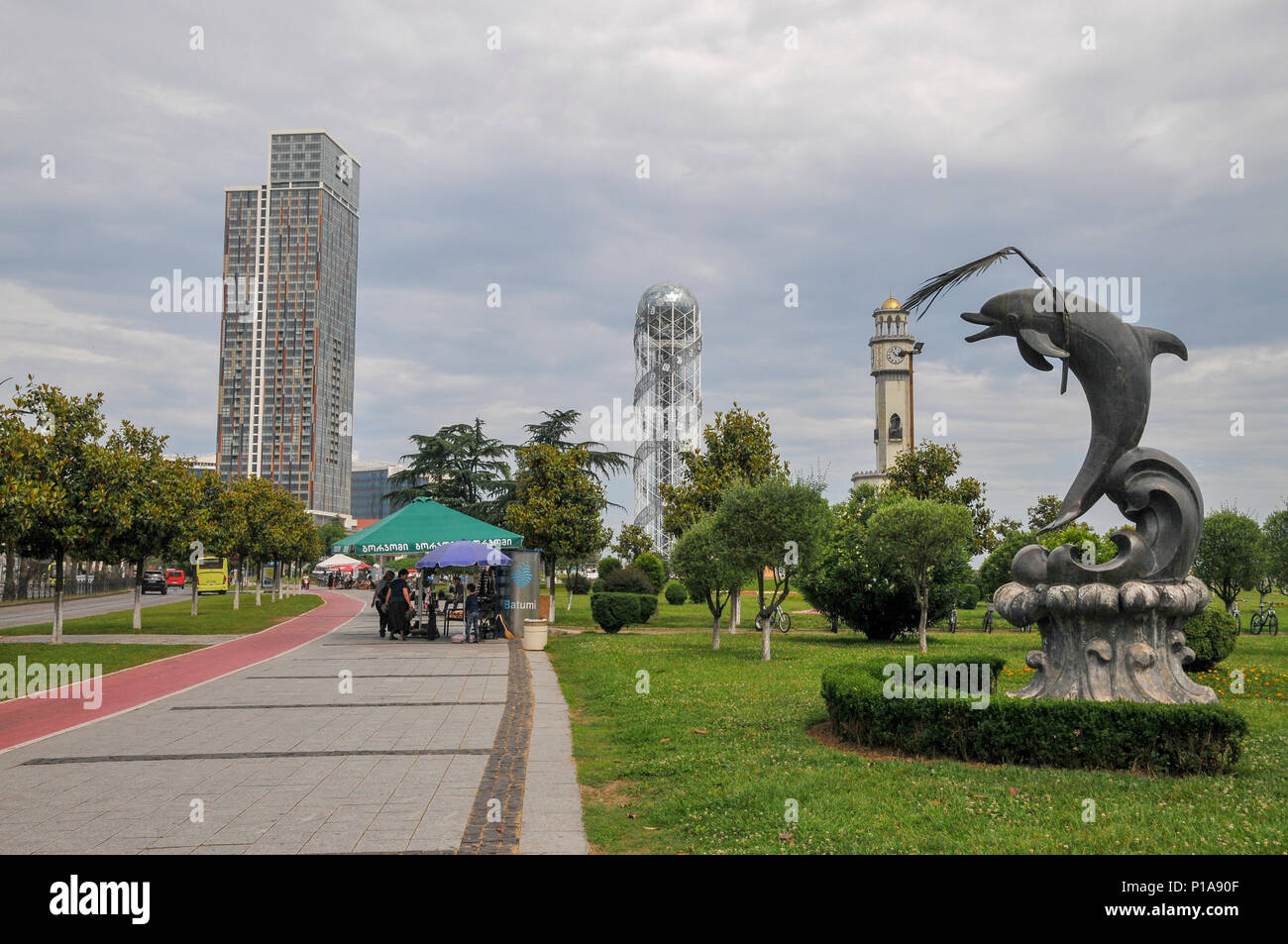 Dolphin statue in Miracle Park. Alphabetic tower and the old clock ...
